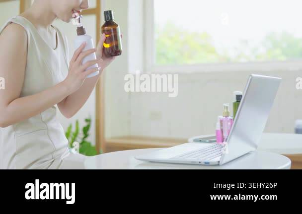 Woman holding bottles near laptop in bright room Stock Video Footage ...