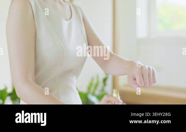 Woman applying cream in bright room Stock Video Footage - Alamy