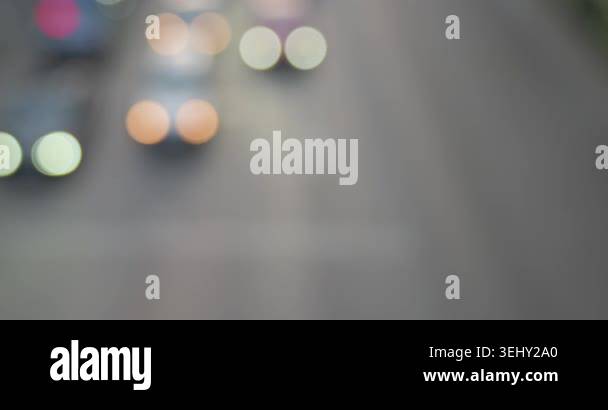 Blurry bokeh background of urban rush hour traffic with glowing vehicle ...