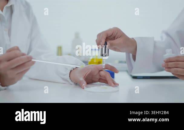 scientists applying liquid from dropper onto hand Stock Video Footage ...