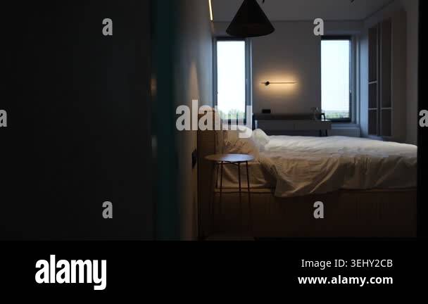 Cozy Bedroom With Unmade Bed And Window View, Soft Ambient Lamp Casting ...