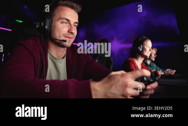 Group of friends, gamers wear headsets playing video games together in ...