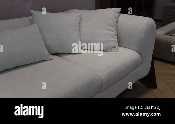 Modern grey sofa closeup with plush cushions and soft upholstery ...