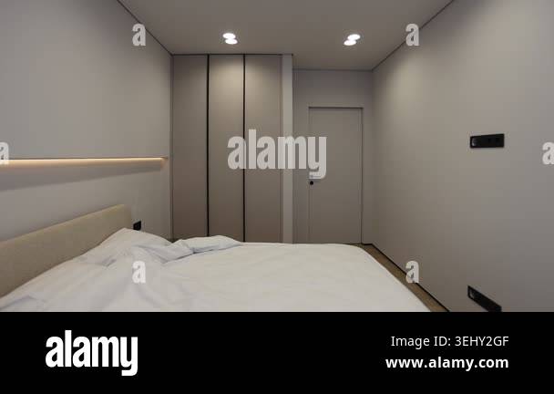 Minimal gray bedroom with bed, soft LED headboard strip, builtin ...