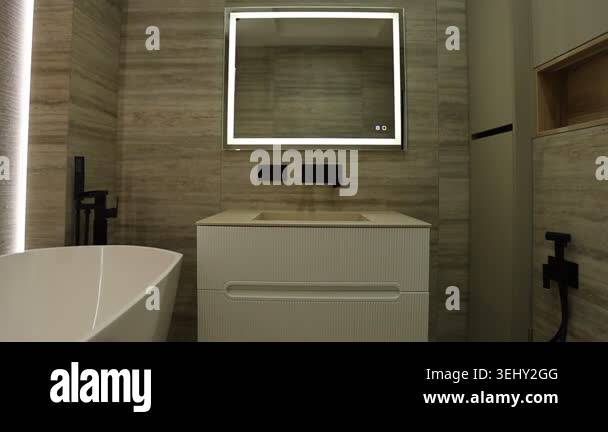 Modern vanity under illuminated LED mirror with soft backlight, sleek ...