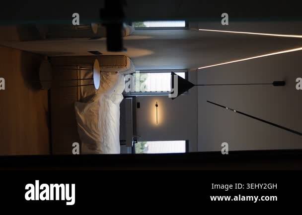 Moody bedroom with angled black lamp, soft dusk light, diagonal LED ...