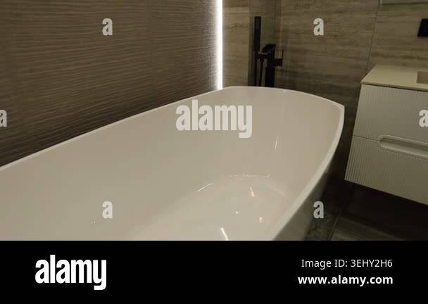 Closeup sculptural freestanding bathtub edge and curved interior ...