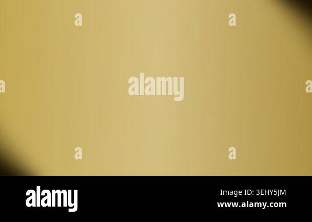 A smooth gradient surface featuring a warm and elegant golden light ...
