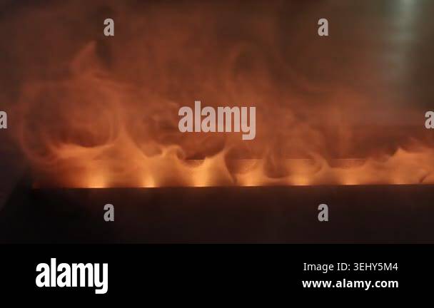 Soft low flame with rising smoke, moody ambient scene with gentle ember ...