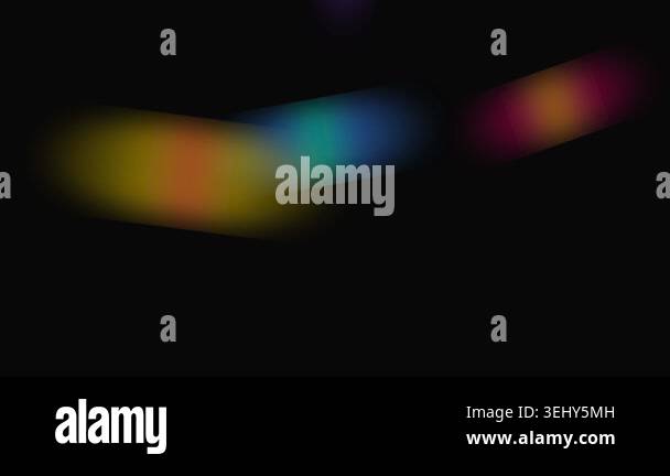 Soft colorful light flares glowing against a deep solid black ...