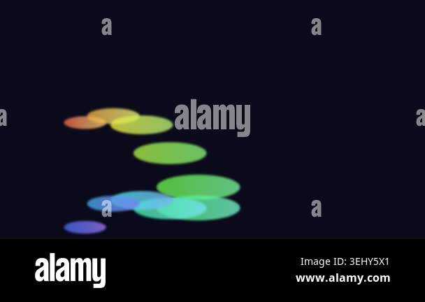 Abstract path of colorful glowing bokeh circles against a dark ...