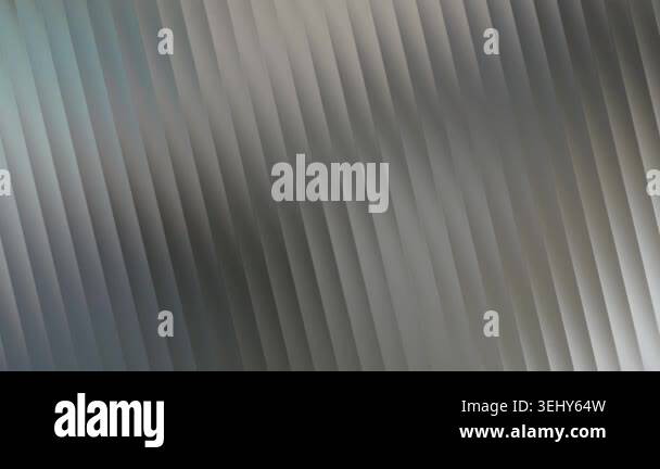Vertical blinds with soft light and shadow creating a textured abstract ...