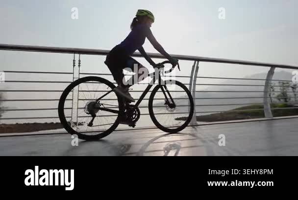 Person Riding bike on seaside road Stock Video Footage - Alamy
