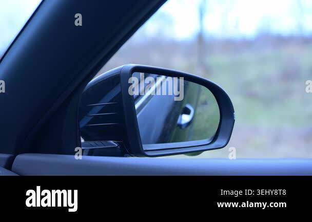 Rear view mirror adjustment. A glimpse of serene nature is captured in ...