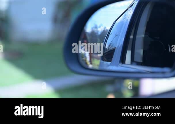 Rear view mirror adjustment. A cars side mirror captures reflections of ...