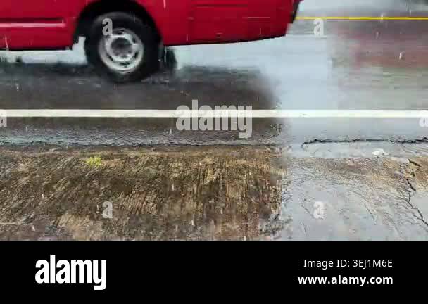Rainy Day Traffic on Wet City Street with Vehicle Reflections Stock ...