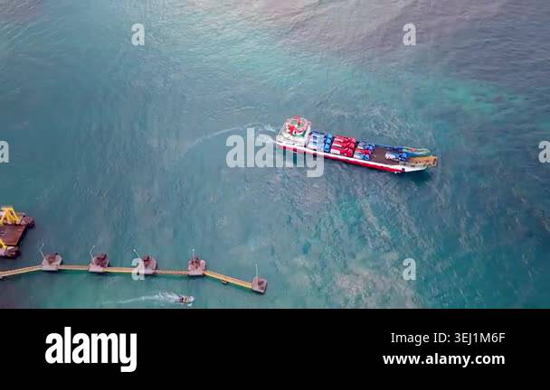 Aerial view of a large car ferry navigating the turquoise waters of ...