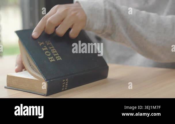 Person reading scripture and praying in a quiet moment of devotion ...