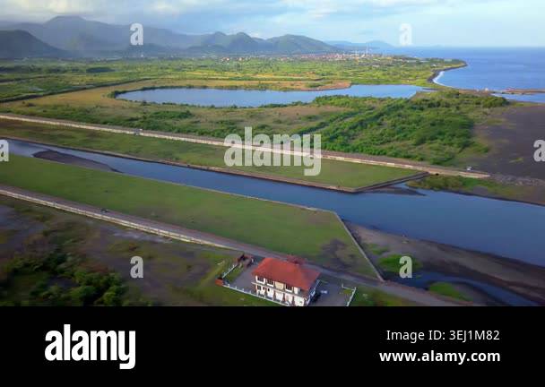 Aerial View of Pusat Kebudayaan Bali Estuary with Mountains and Lake in ...