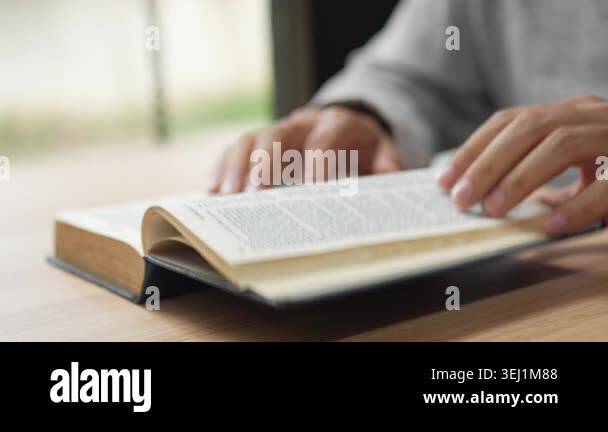A person praying and reading the Bible for spiritual reflection and ...