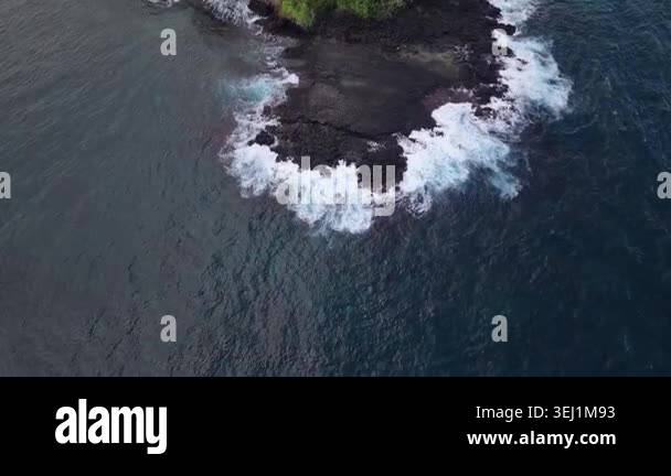 Aerial View of Lighthouse on Rocky Cliff with Crashing Waves in ...
