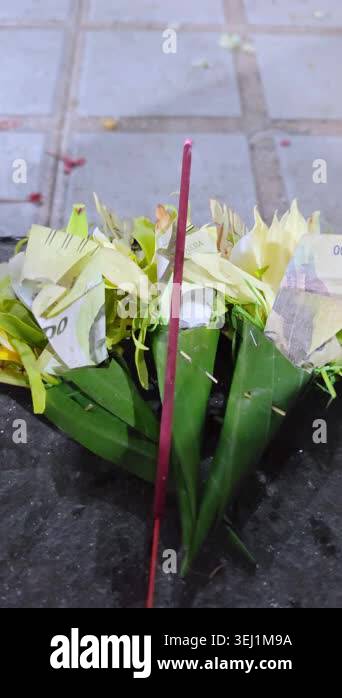 Balinese Hindu Kwangen Offering with Flowers and Burning Incense Close ...