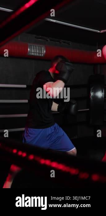 Two professional boxers fighting during a sparring session in a dark ...