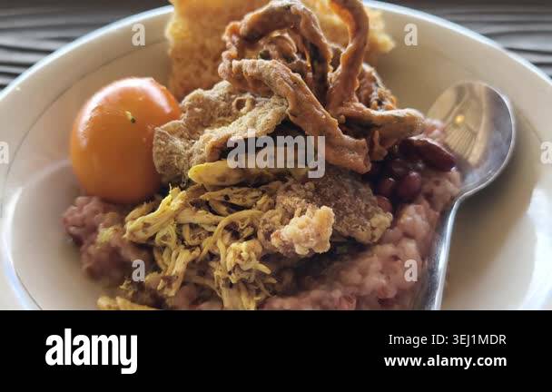 Traditional Balinese red rice porridge bubur merah served with chicken ...