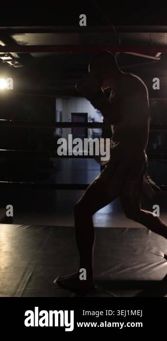 Silhouette of a man practicing martial arts punches and footwork in a ...