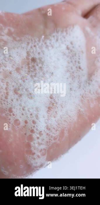 Spreading soap foam bubbles on palm and showing it from close up. Hand ...