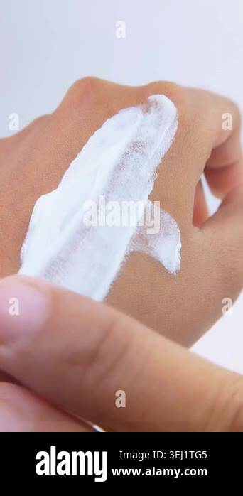 Applying thick white cream to hand skin. Self care concept with white ...