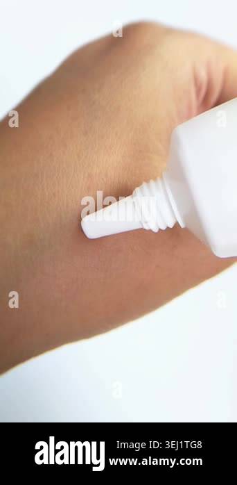 Pouring white cream onto skin. Skincare and beauty concept isolated on ...