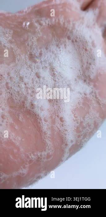 Close up view of palm of hand filled with rich cleansing soap foam ...