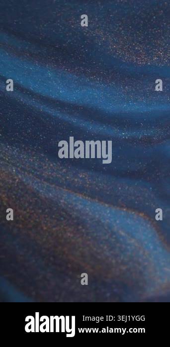 Vertical video. Spilling fluid. Mix color. Defocused blue orange bronze ...