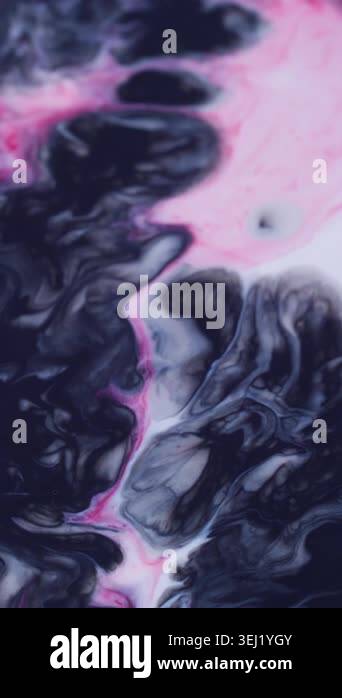 Vertical video. Ink splatter. Blend color. Defocused red pink liquid ...