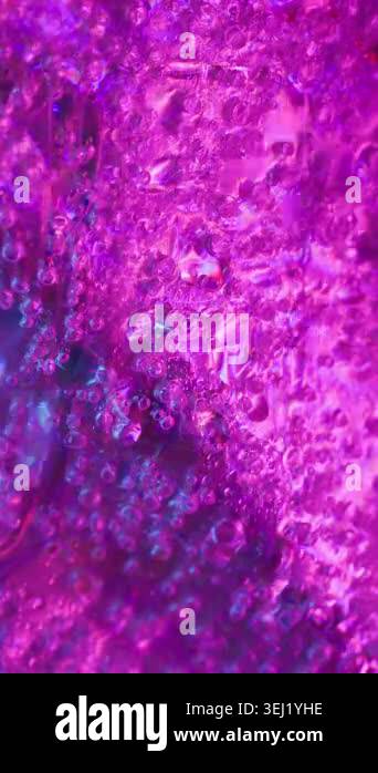 Vertical video. Droplet art. Liquid light. Defocused blue pink neon ...
