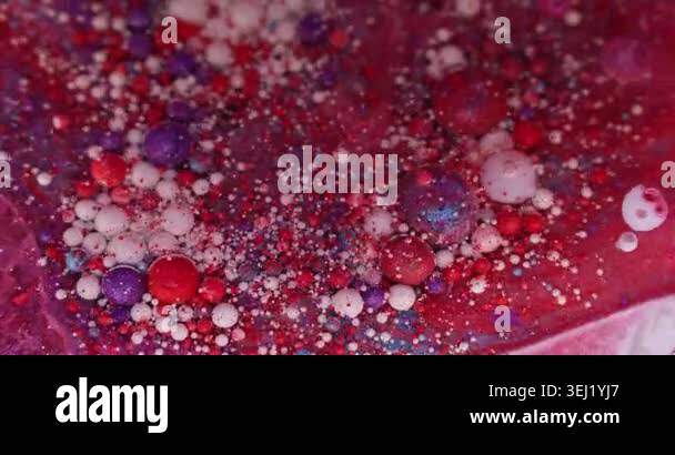 Round particles. Ink oil fluid. Defocused red blue purple colorful ...
