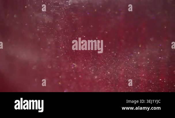 Shimmering defocused flow. Shiny particles glare. Red pink bokeh powder ...
