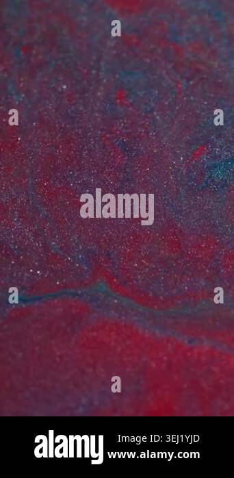Vertical video. Shimmer ink. Sparkling texture. Defocused red blue ...