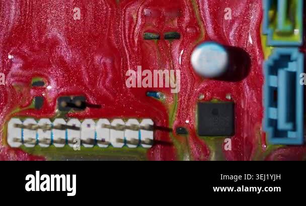 Electronic components. Glitter stream. Red yellow paint spill on ...