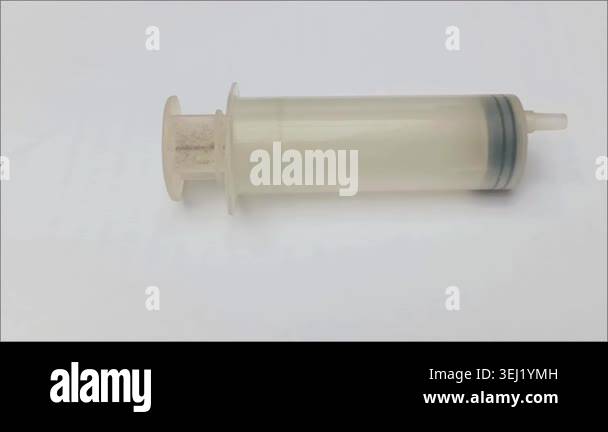 Close up of big empty plastic syringe without needle on white surface ...