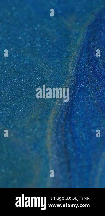 Vertical video. Shimmer ink. Sparkling texture. Defocused blue yellow ...