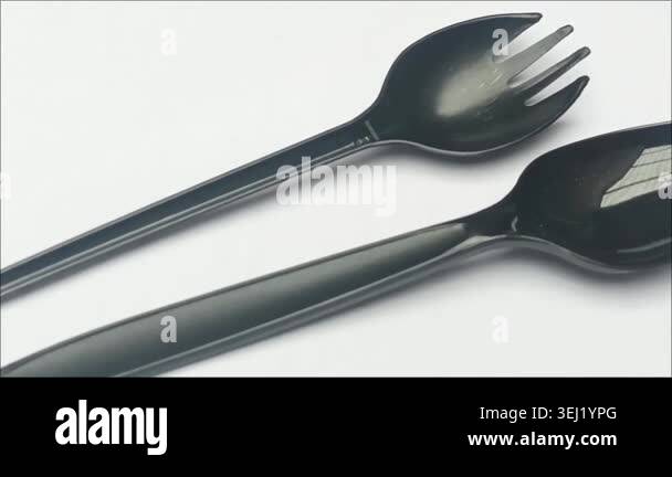 High angle view of disposable black plastic spoon and fork isolated on ...