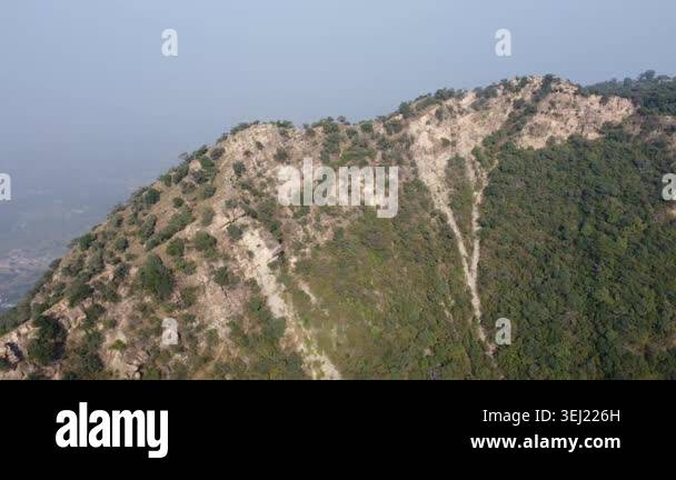Far jungle and distant settlement seen beyond tilla jogian limestone ...