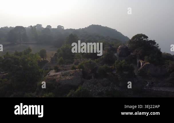 Tilla jogian aerial orbit around historic hilltop domed temples showing ...
