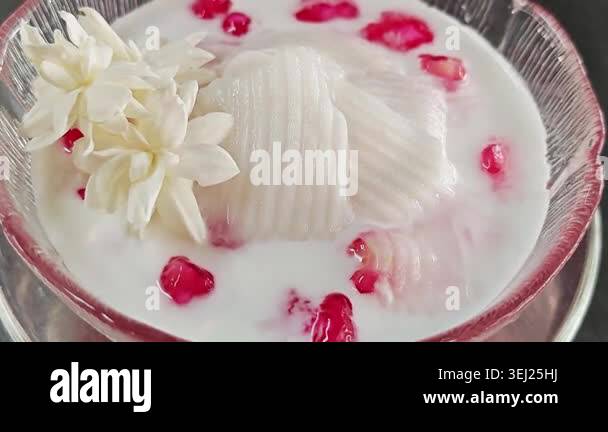 Traditional Thai dessert Thapthim Krop with coconut milk and young ...