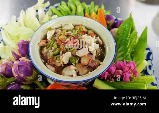 Close-up of Thai chili paste dip with shrimp and carved vegetables ...
