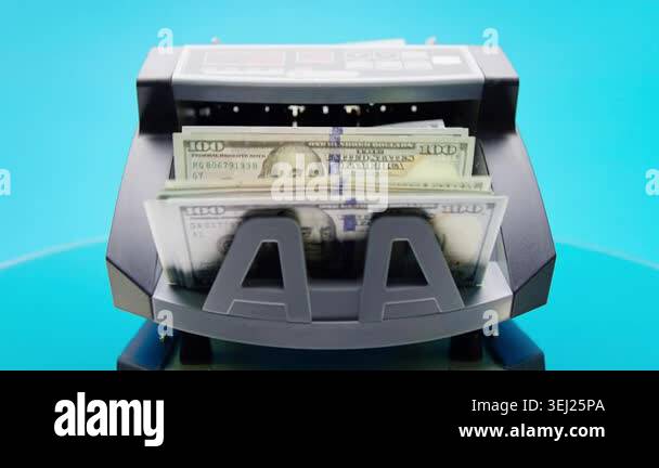 Front view of a money counting machine processing US hundred dollar ...