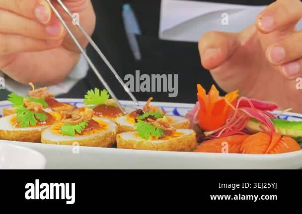 Chef's hands using tongs to garnish Thai fried boiled eggs Stock Video ...