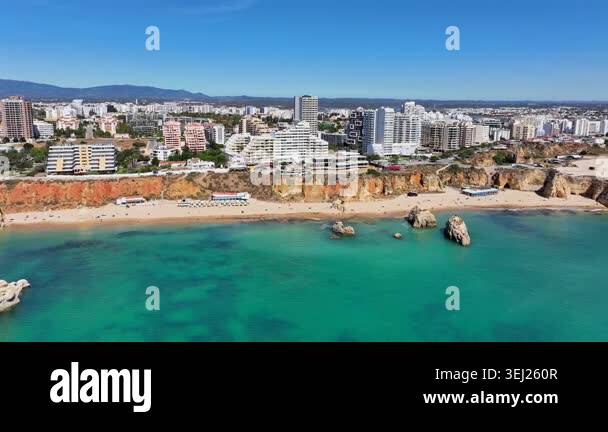 Aerial view flying along the coastline of Praia da Rocha near Portimao ...